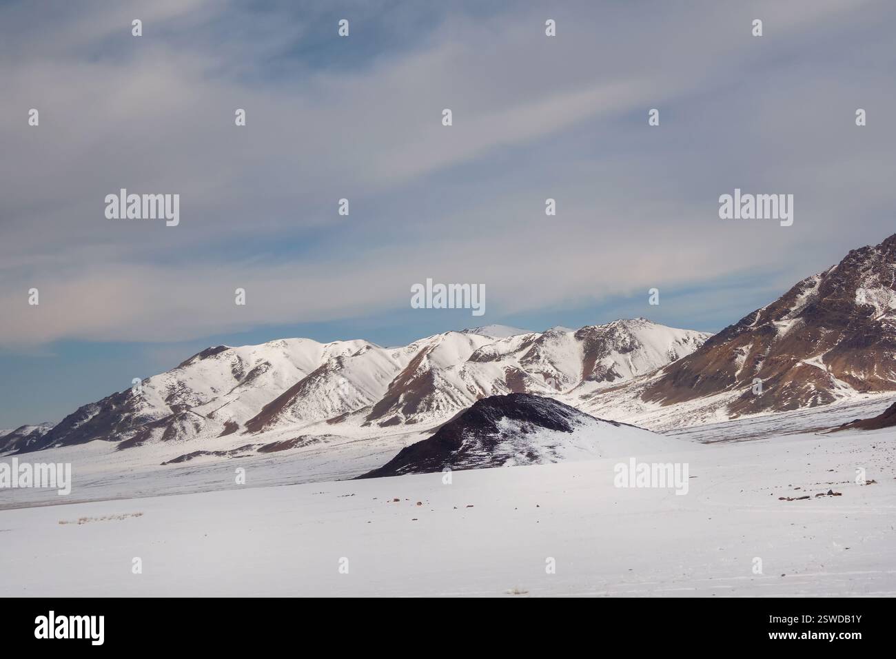 Cold snow-white landscape of snowy valley. Snow-covered rocky mountain ...