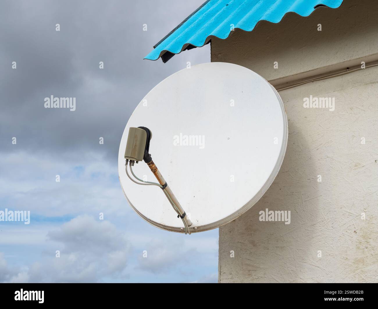Satellite internet and TV signal receiver antenna on the house wall ...