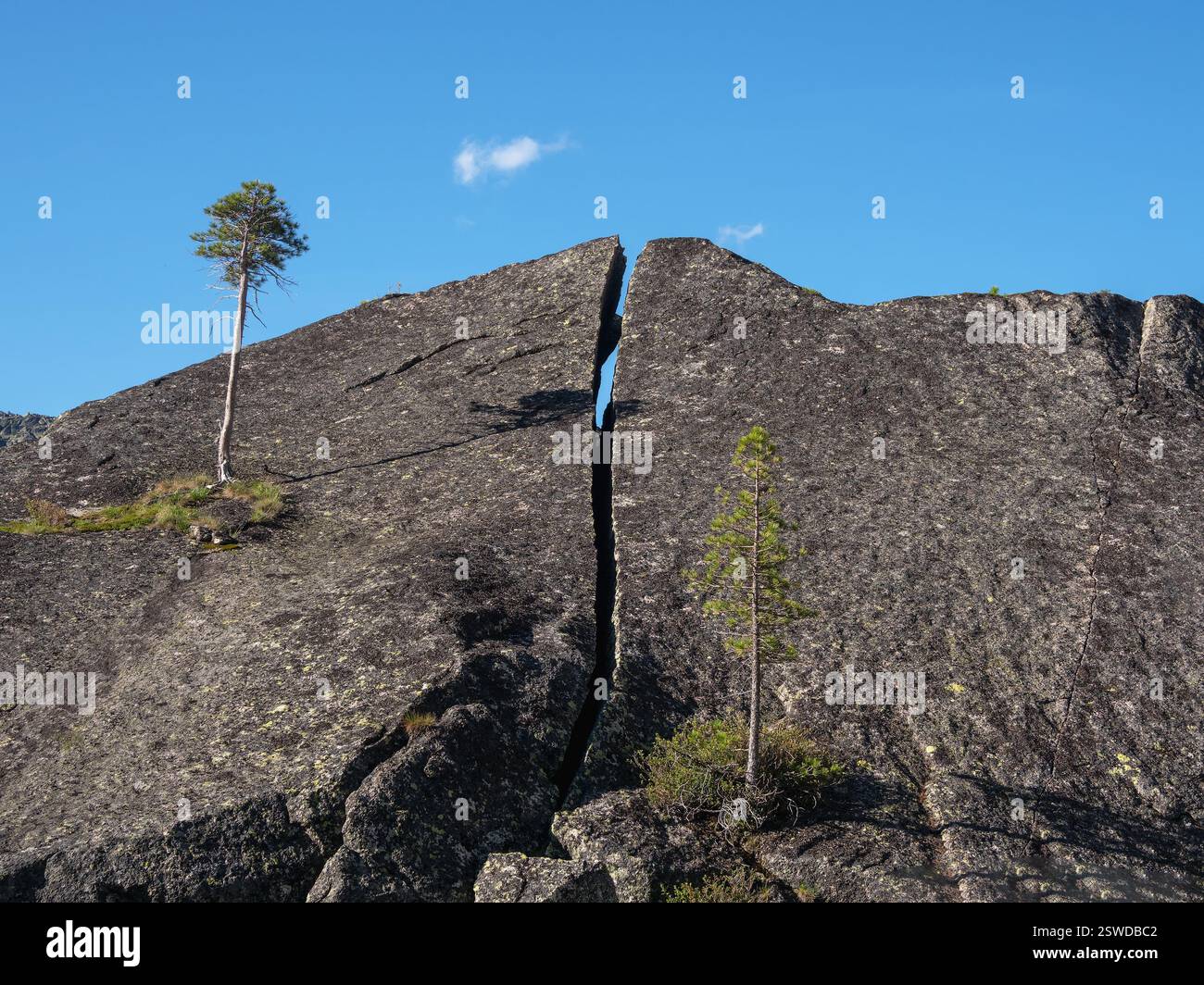 Huge granite boulder is split in half. The crack in the granite ...