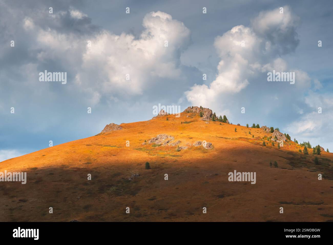 Amazing mountain landscape with cone rock in golden sunlight under ...
