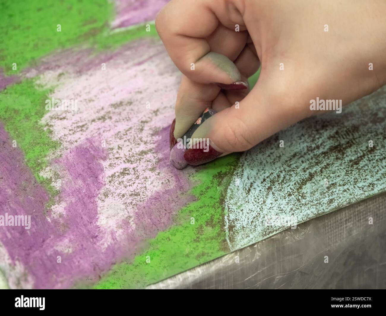 Hand is in motion. Drawing with pastels close-up. Woman drawing ...