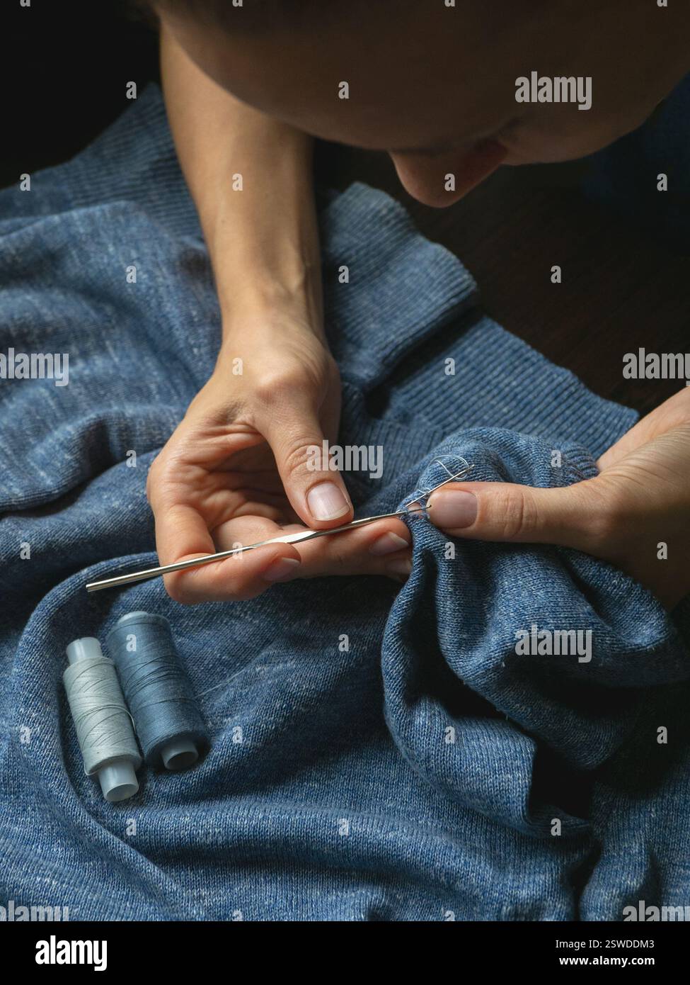 A hole in the clothing. Crocheted clothing restoration Stock Photo - Alamy