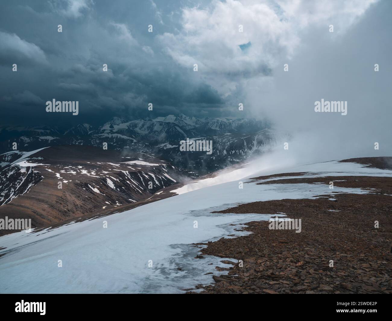 Wonderful dramatic landscape with big snowy mountain peaks above low ...