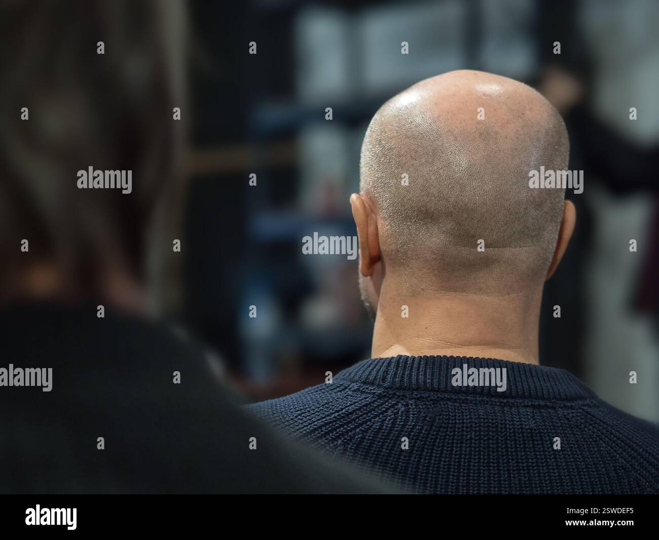 Back view of the man with a bald head in a conference hall Stock Photo ...