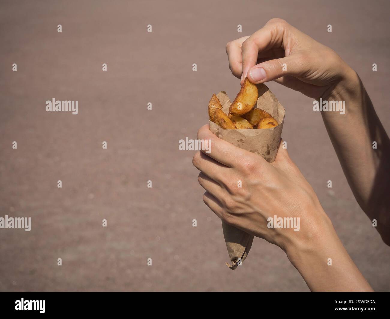 Potato snacks in the hands. Snack on the go. Delicious potato chips Stock Photo - Alamy