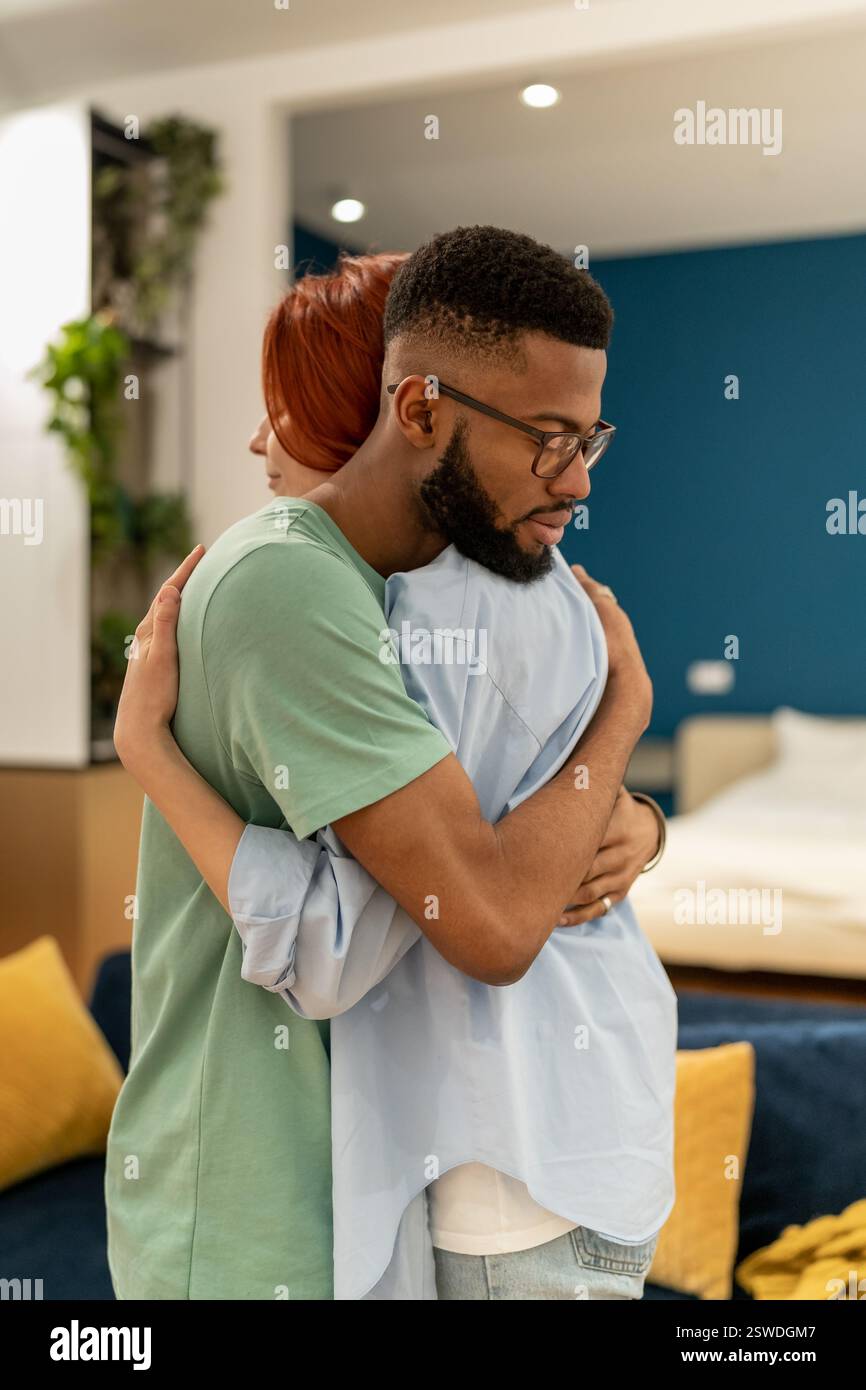 Loving supportive husband embracing his wife gently at home. Love and ...