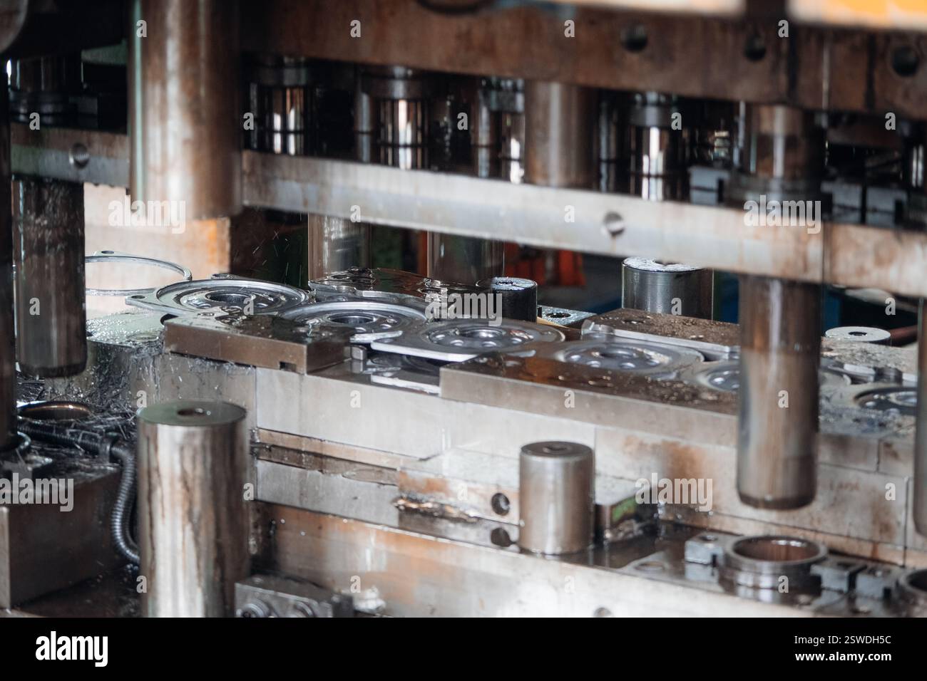 Metal parts stamping machine in operation Industrial manufacturing ...