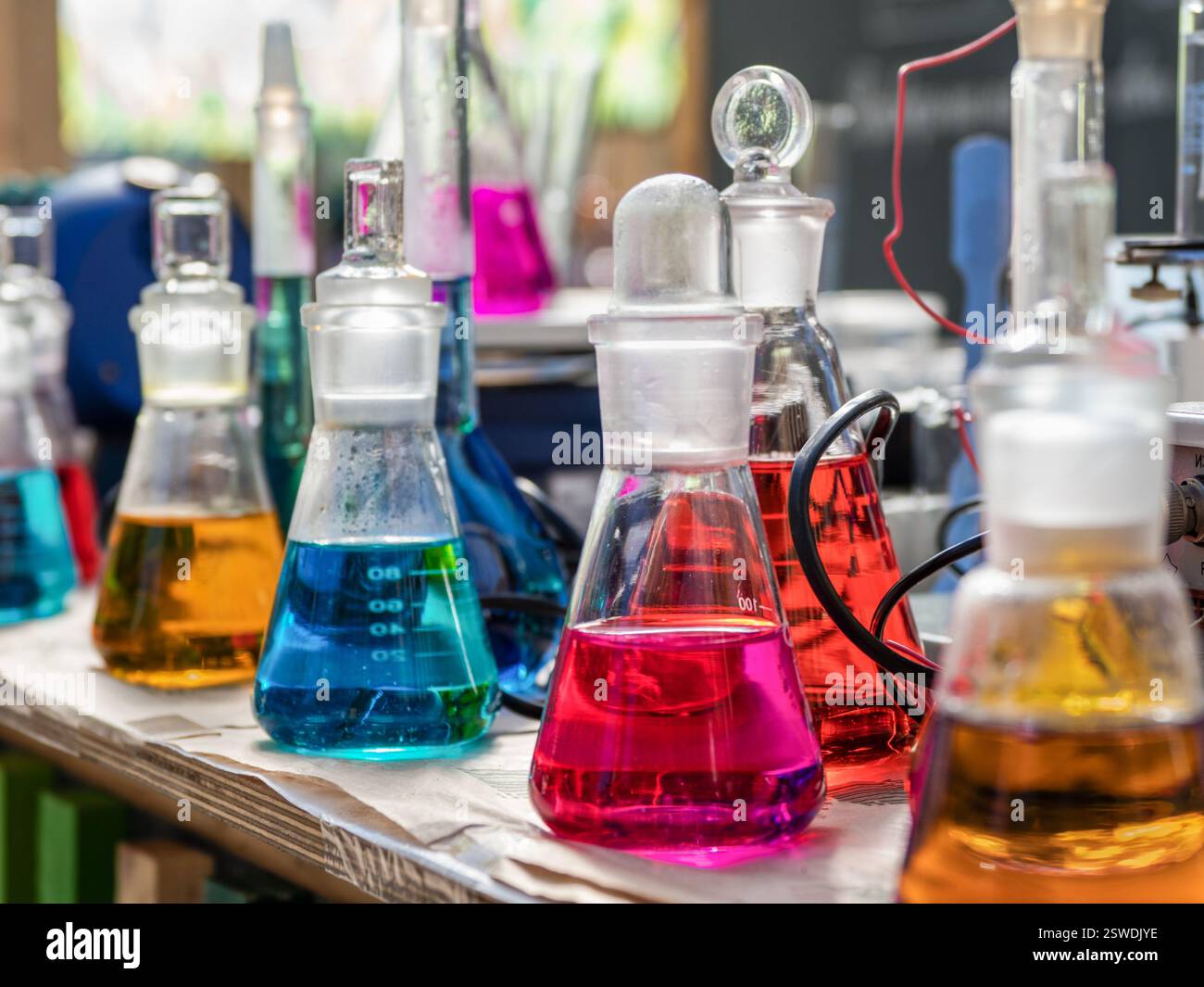 Flasks with colored reagents on the table Stock Photo - Alamy