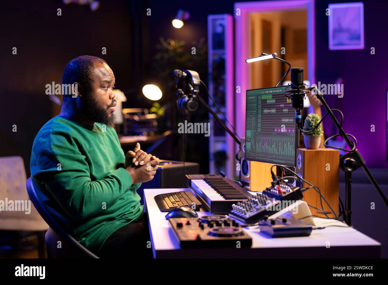 African american sound engineer using midi controller notes to add ...