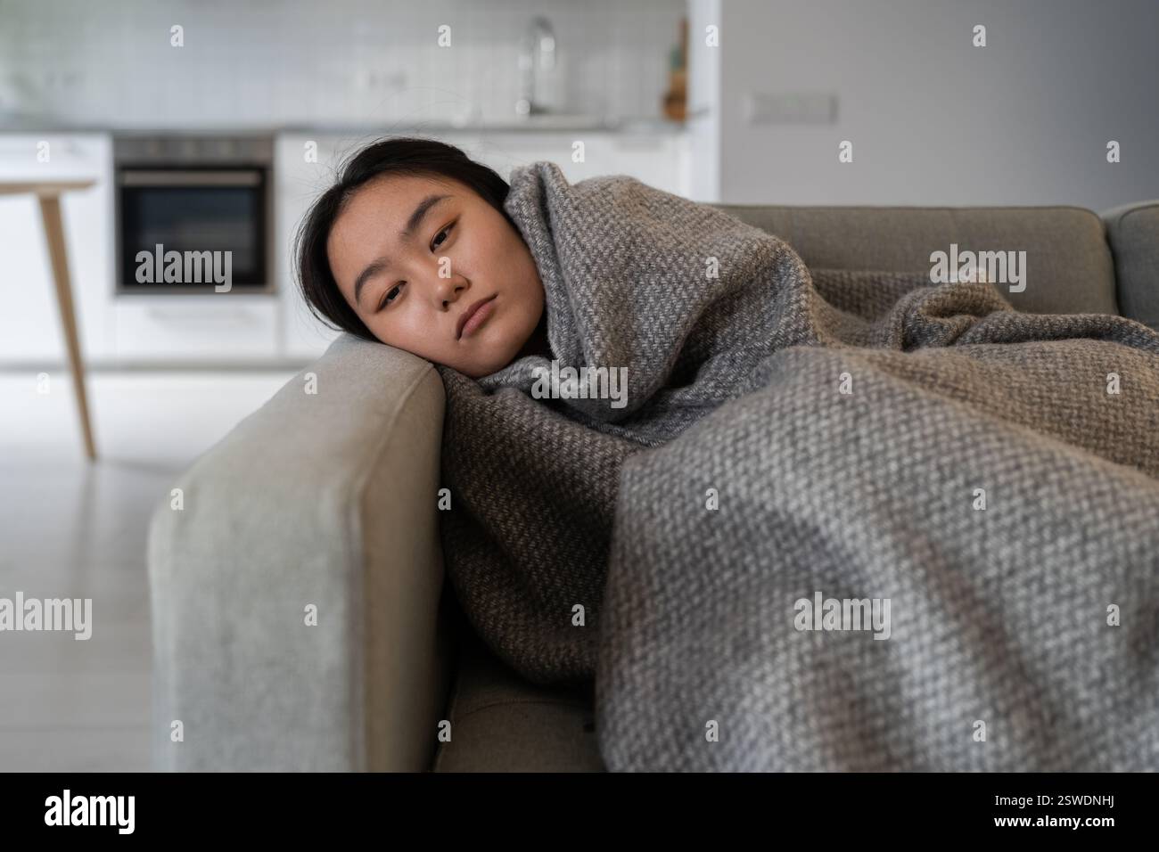 Sick depressed woman covered plaid hi-res stock photography and images ...