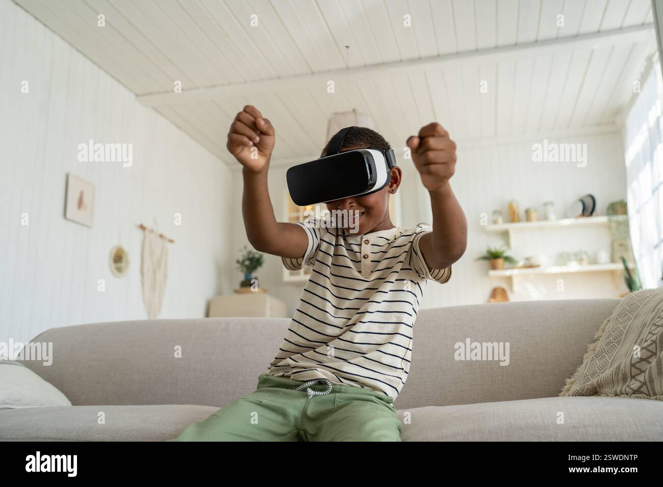 Focused african american boy drives car plays racing video game in ...