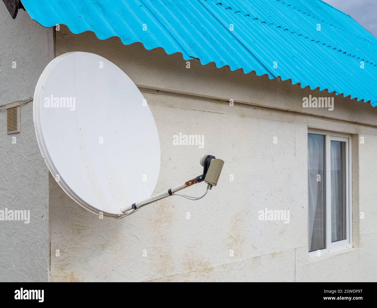 Satellite dish at home roof installed, close up. Satellite dish and TV ...