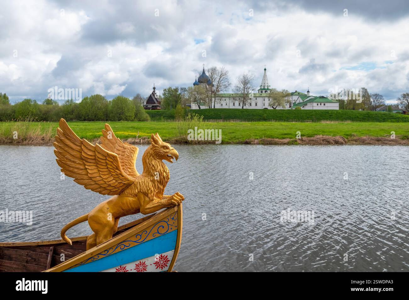 Golden winged Griffin on an ancient wooden boat against the background ...