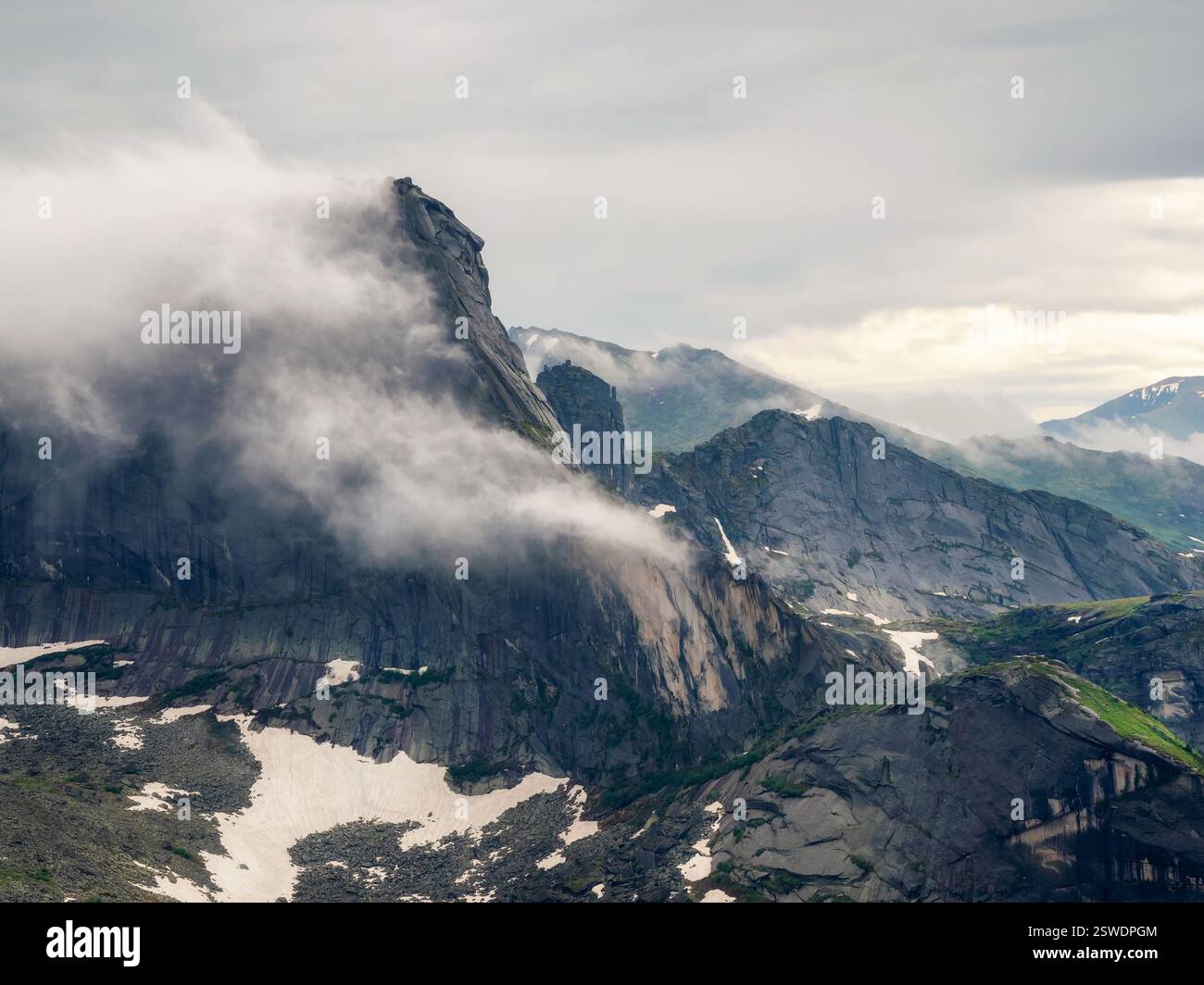 Dramatic fog among giant rocky mountains. Low clouds and beautiful ...