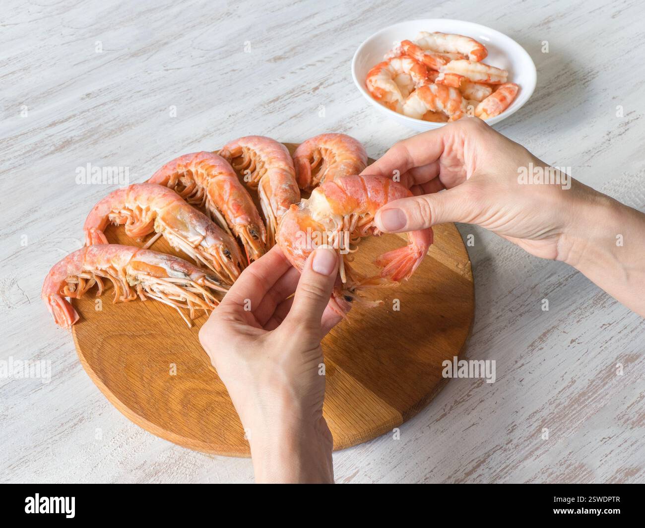 Manual peeling of an prawns. Cooked fresh giant shrimps, close up Stock ...