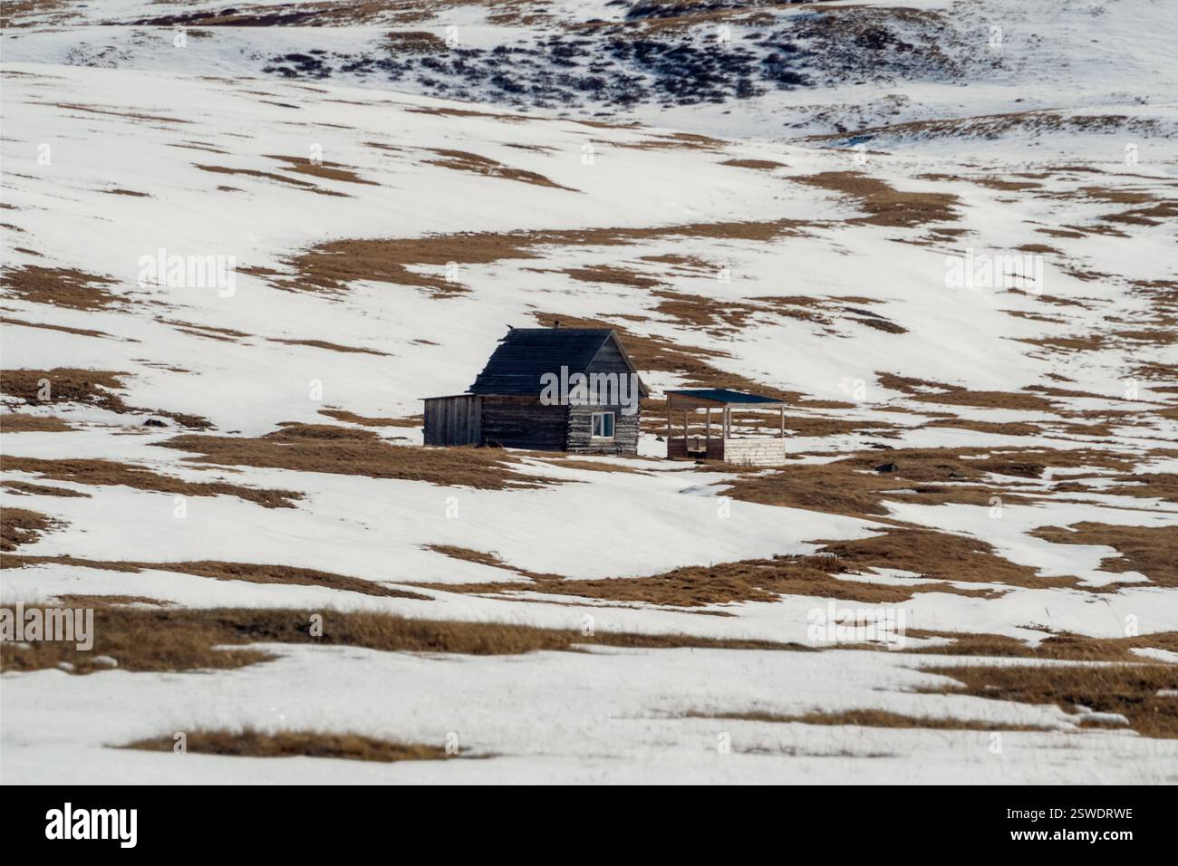 Remote mountain cabin by a frozen lake Stock Photo - Alamy