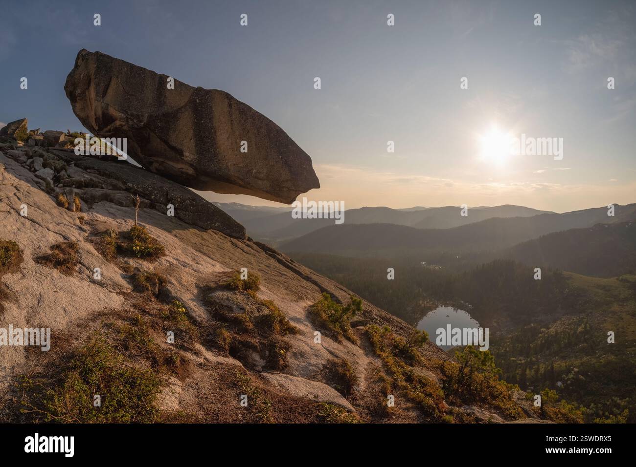 An unusual phenomenon of nature - large granite boulder hangs over the ...