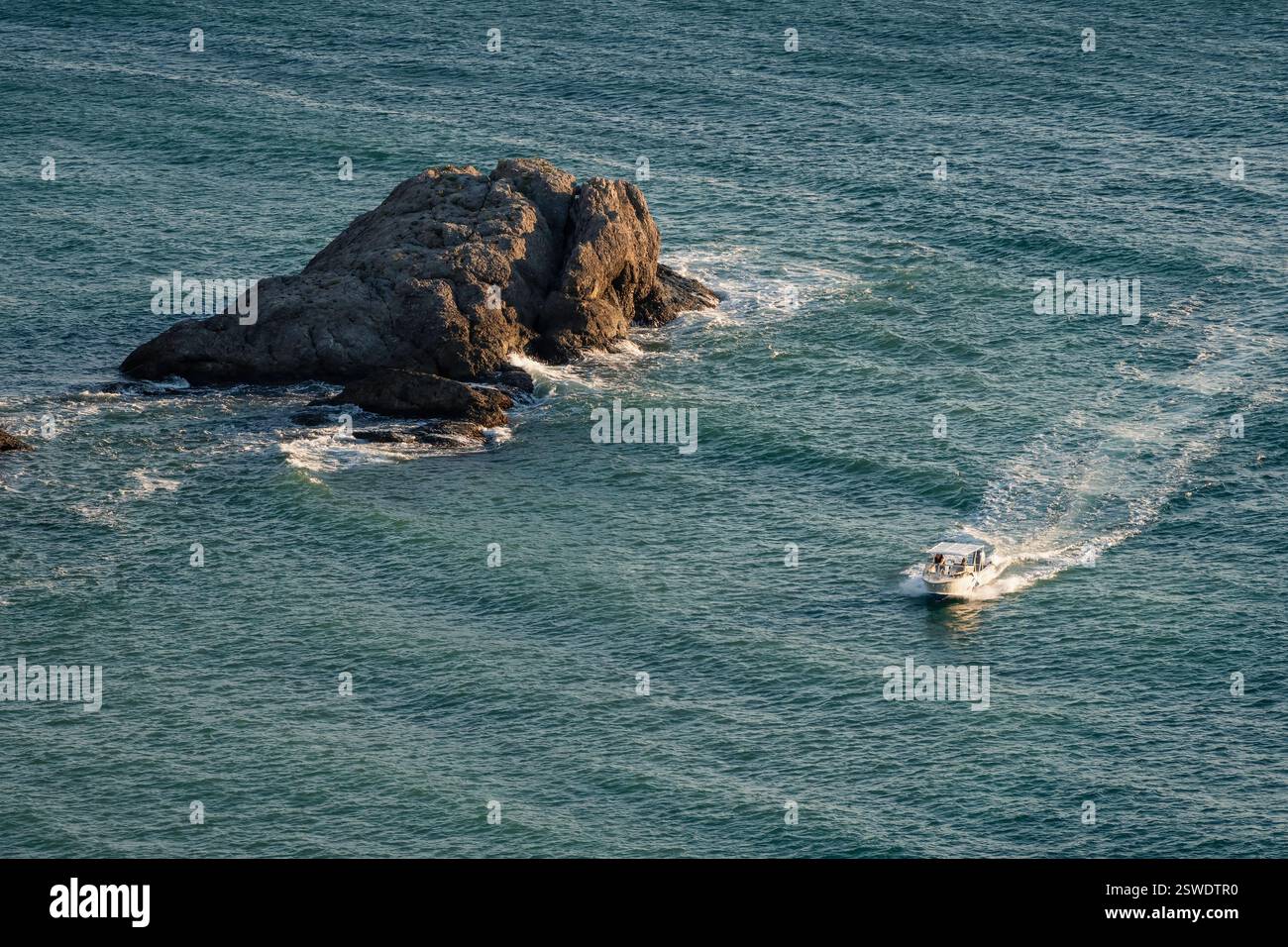 Black sea coast. Little boat in the sea near rock cliff. White boat ...