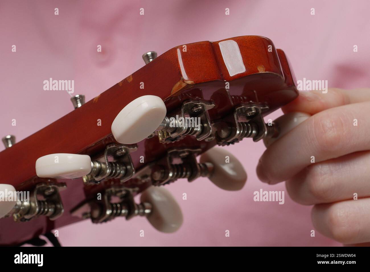 Extreme close-up female fingers tuning classical six string acoustic ...