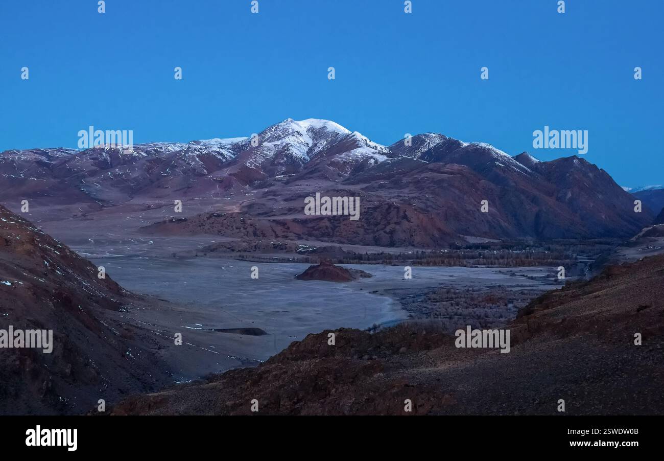 Blue Hour in the mountains. White snowy peak glows in the night Stock ...