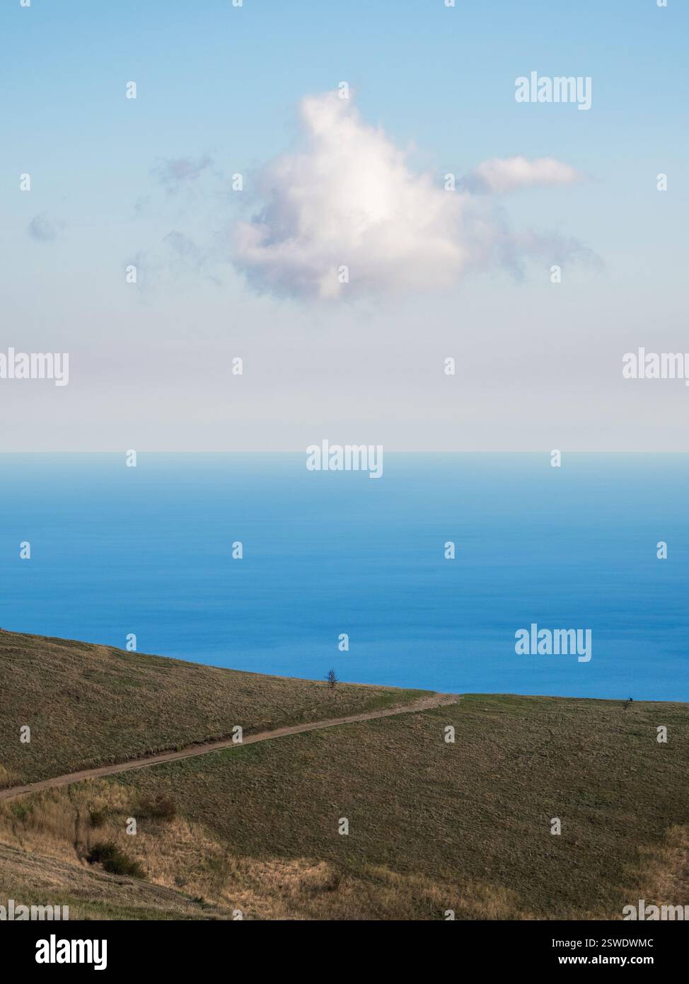 White cloud over the hills and sea. Vertical view Stock Photo - Alamy