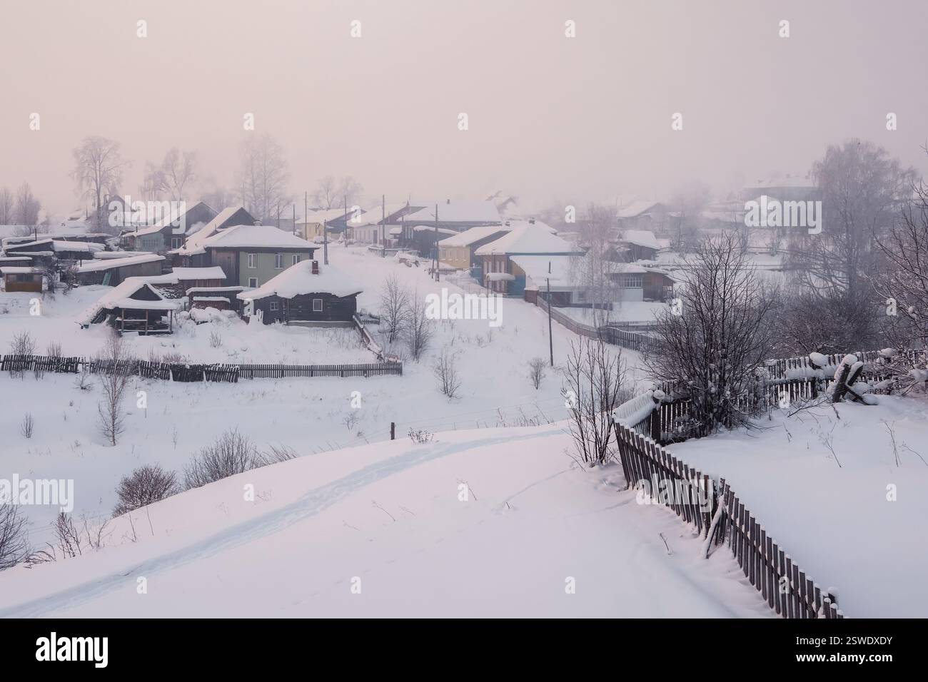 Cold winter in the Russian countryside. Ancient wooden huts under the ...
