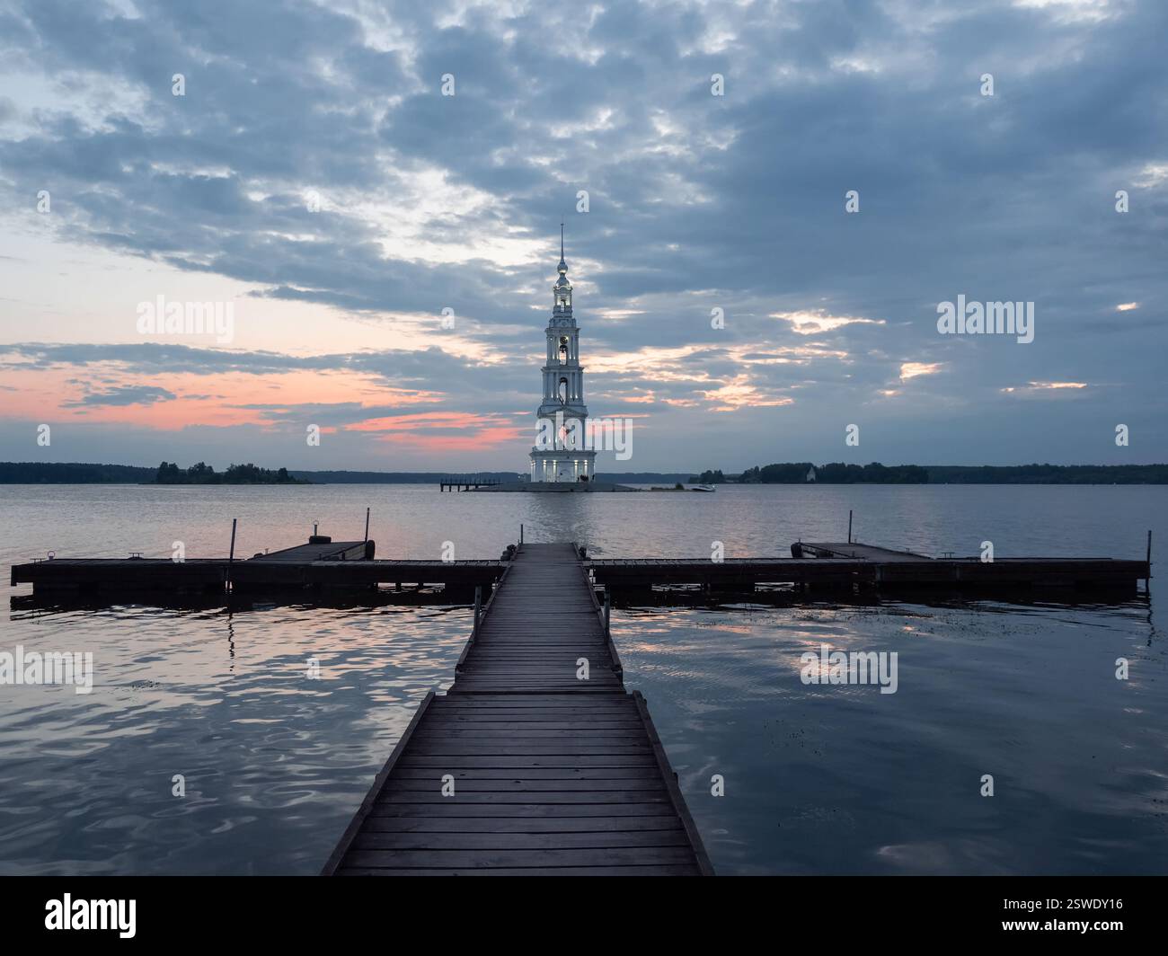 Long wooden pier. Stunning twilight over the bell tower on the i Stock ...