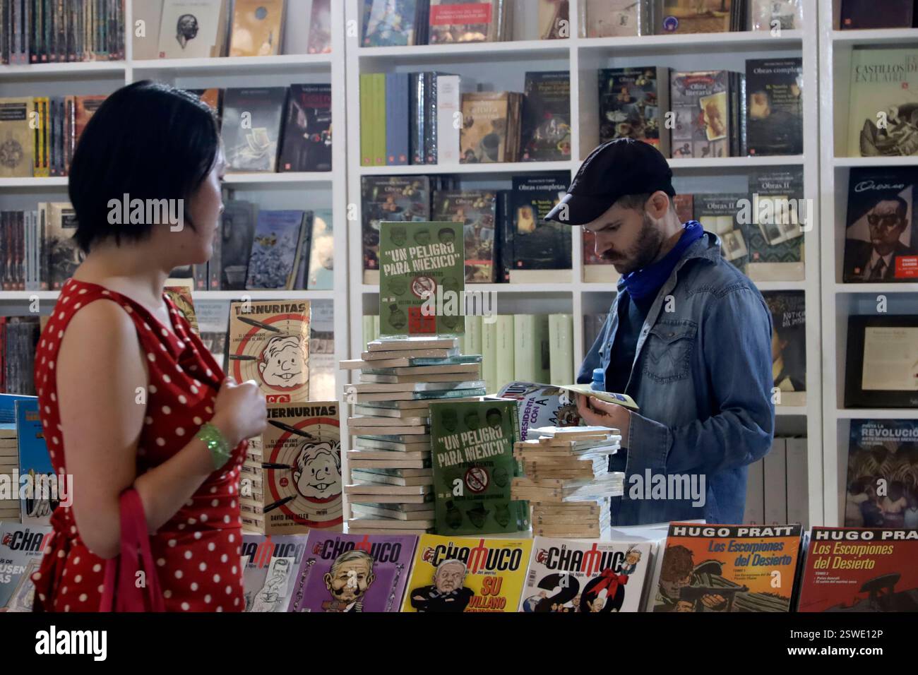 Persons look books during the inauguration of the "El Palacio Postal a ...