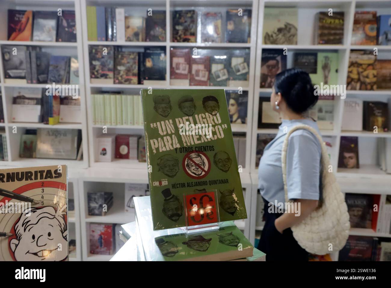 A woman looks books during the inauguration of the "El Palacio Postal a ...