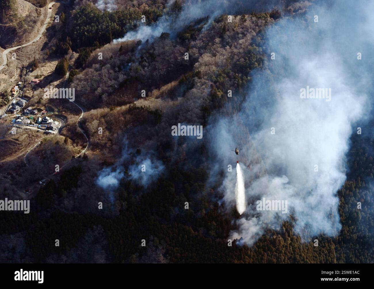 An aerial photo shows a forest fire, continues to spread in Ofunato ...