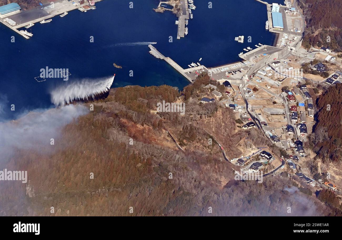 An aerial photo shows a forest fire, continues to spread in Ofunato ...