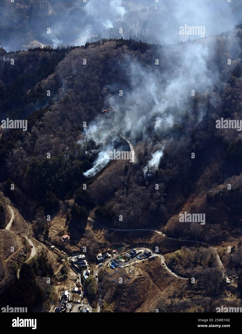 An aerial photo shows a forest fire, continues to spread in Ofunato ...