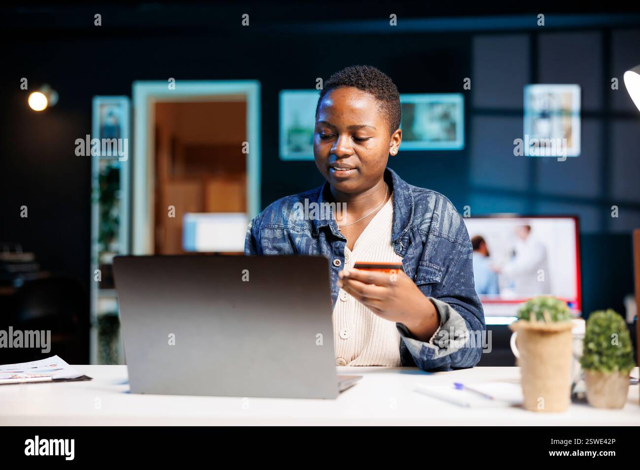 Woman of African ethnicity browsing through online shopping options on ...