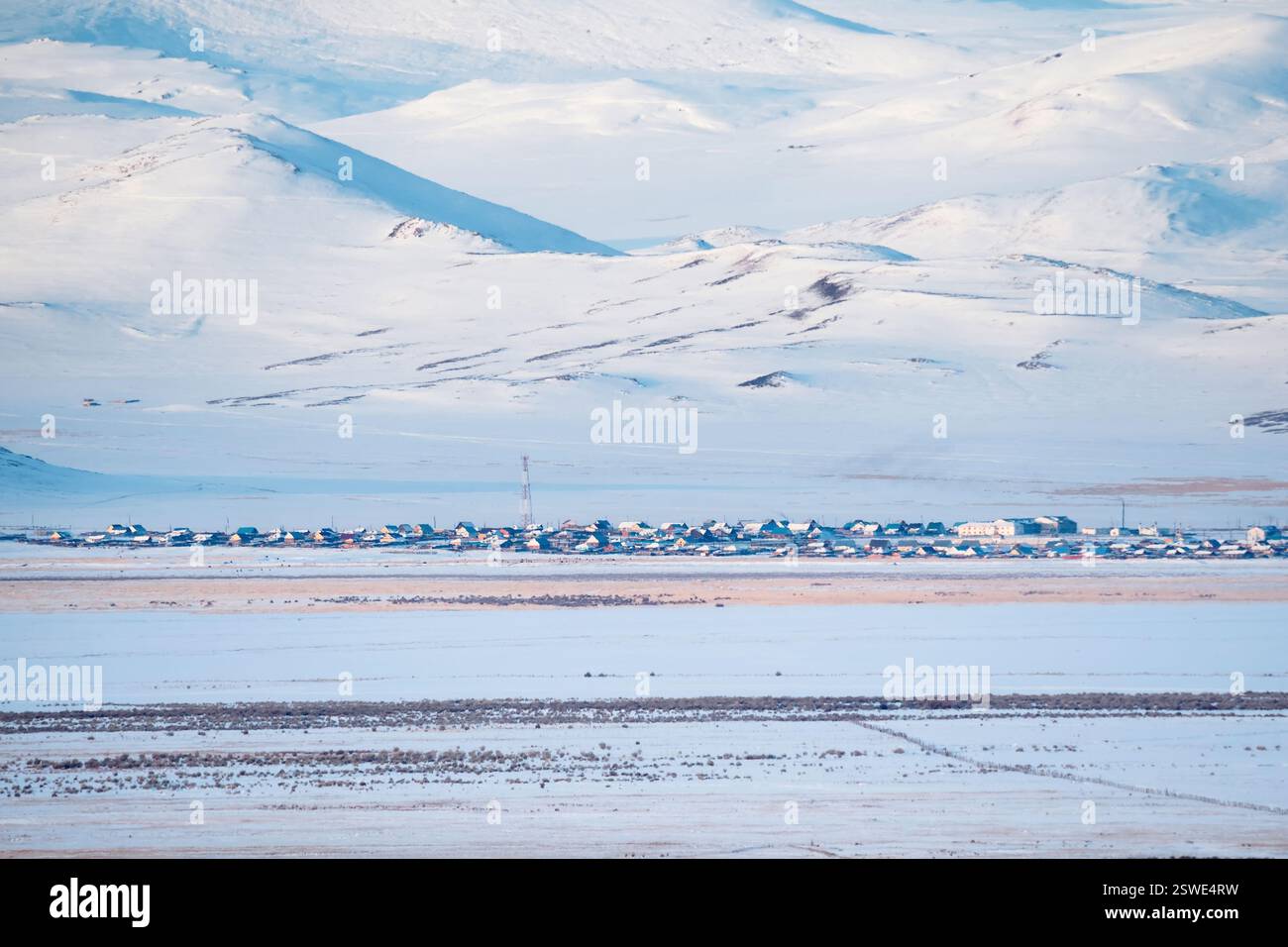 Authentic small town in the distance is covered with snow in the ...