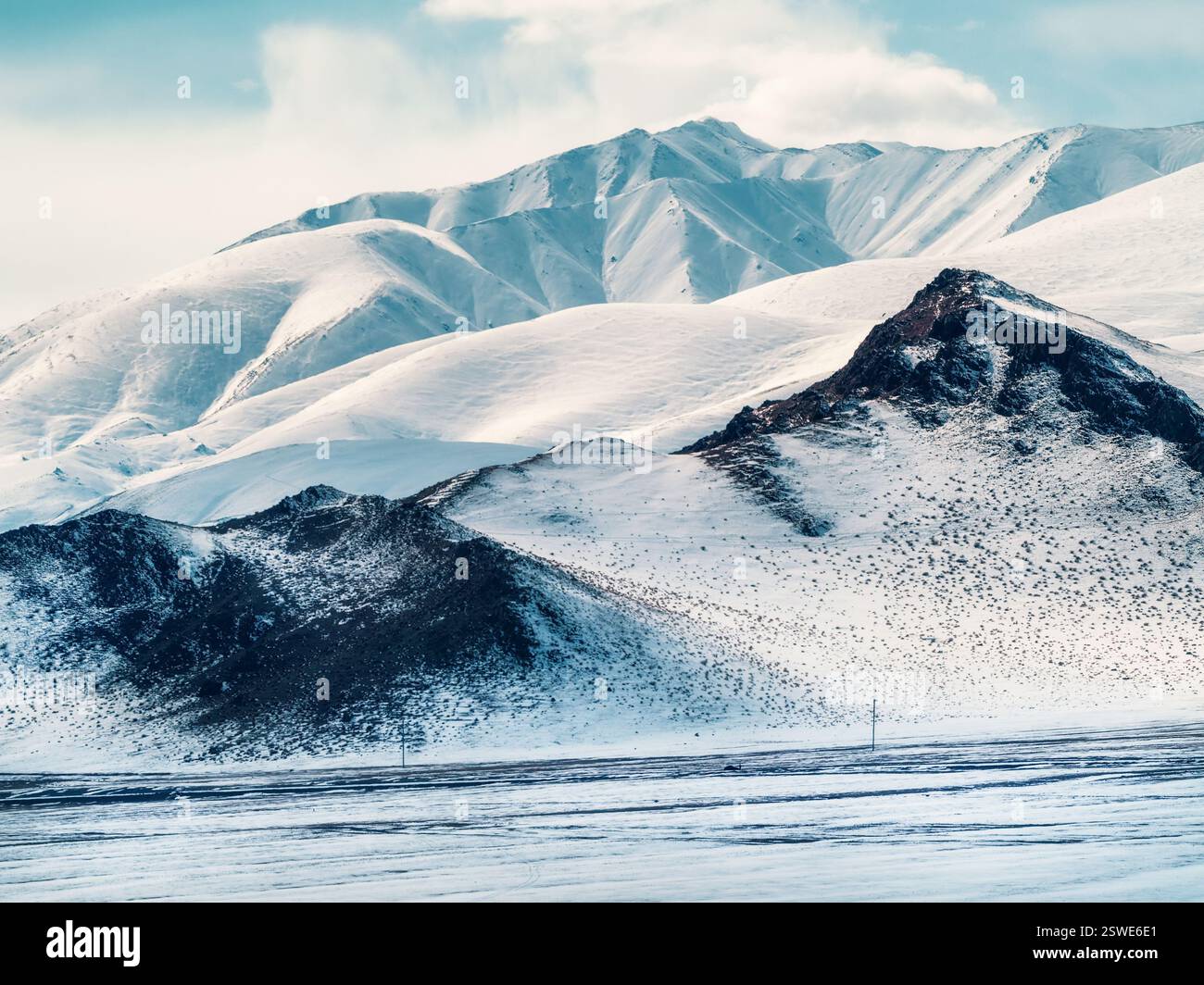 Pastel colors with the snow covered mountains in the distance. Dramatic ...