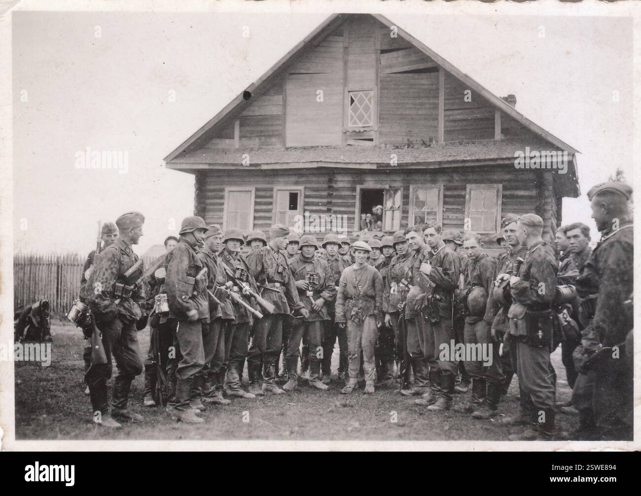 World War Two B&W photo German Soldiers gather around a young Russian ...