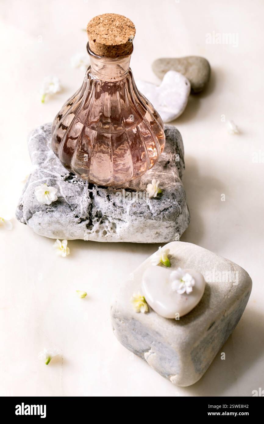 Beautiful pink transparent bottle of perfume with cork, standing on ...