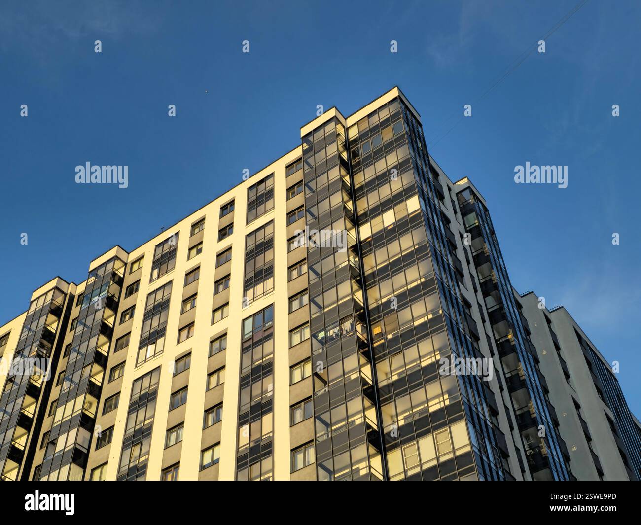 Sunny evening light on the facade of a multi-storey building. Facade ...