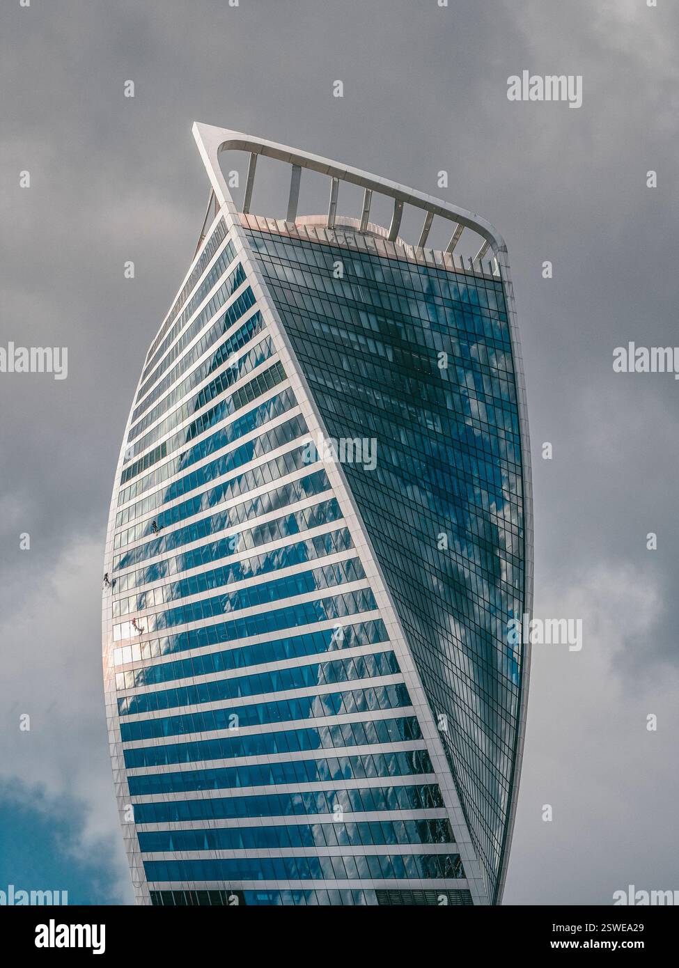 Modern high-rise building made of glass and concrete with small ...