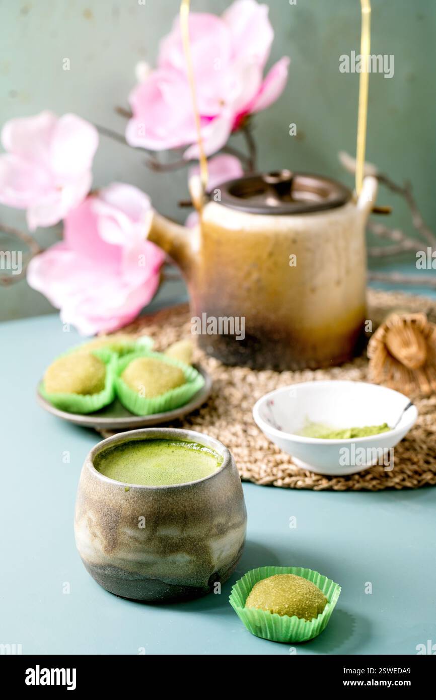 Asian traditional rice dessert sweet green matcha mochi with cup of ...
