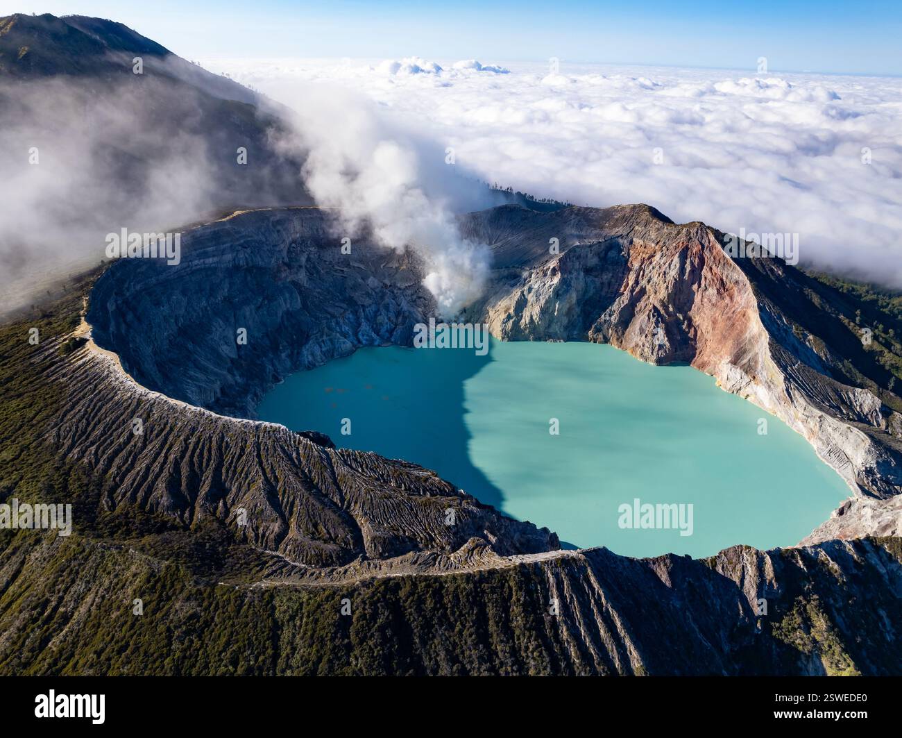 Aerial view Kawah Ijen volcano with turquoise sulfur water lake at sunrise.Amazing nature ...