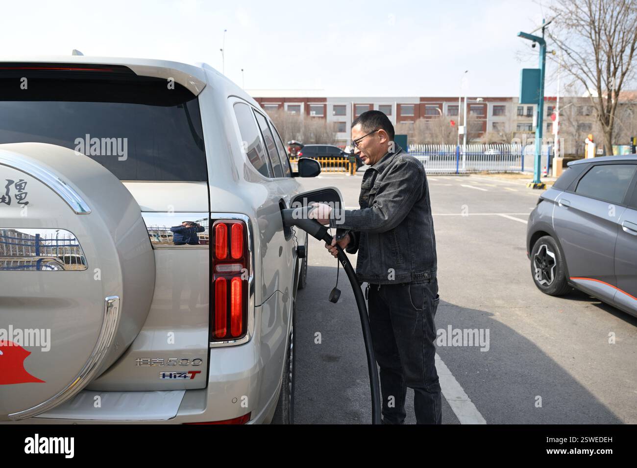 YINCHUAN, CHINA - FEBRUARY 20, 2025 - A new energy owner charges at the ...