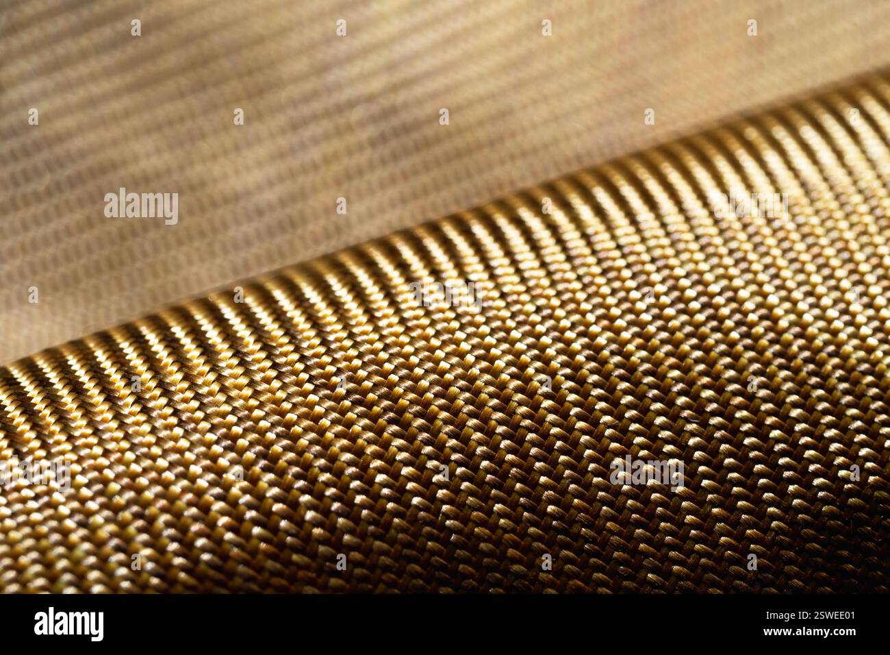 Roll of bulletproof material aramid. Shining aramid kevlar background ...