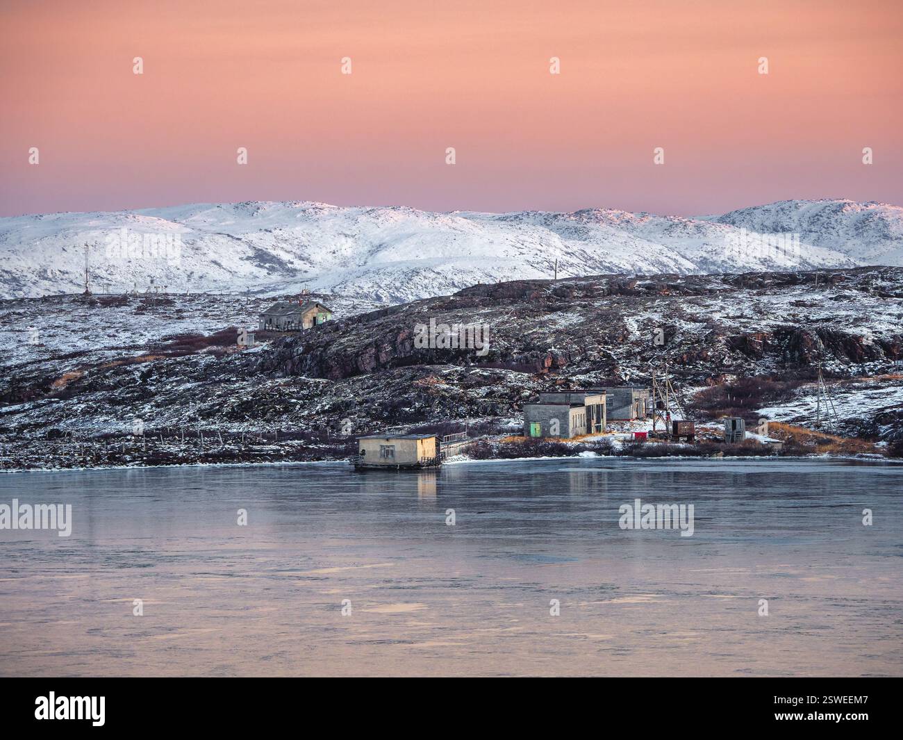 Old fishing lodge on the beach mountain hard-to-reach lakes in Arctic ...