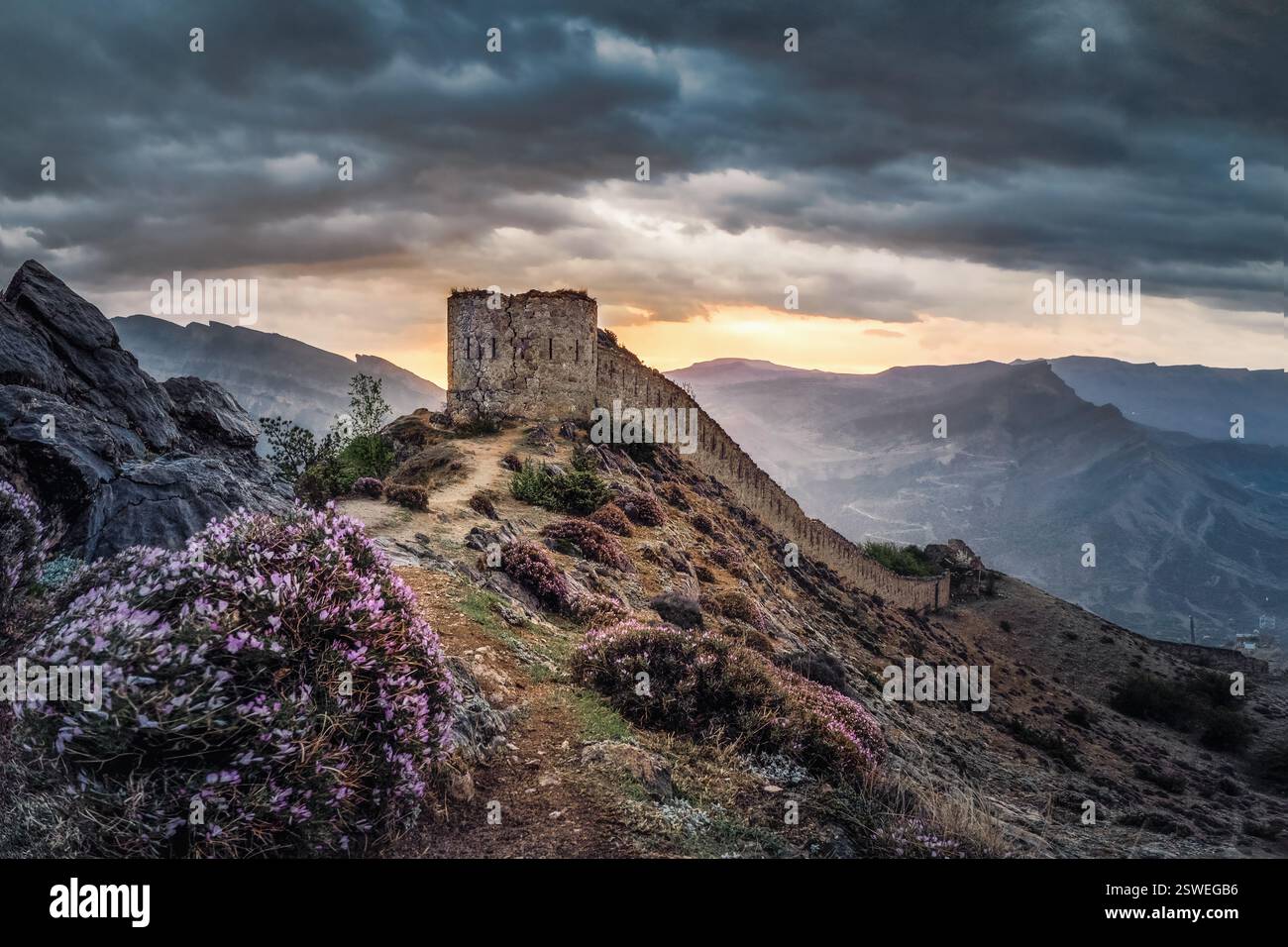 Dramatic sunrise at the ancient fortress on the top of the mountain ...
