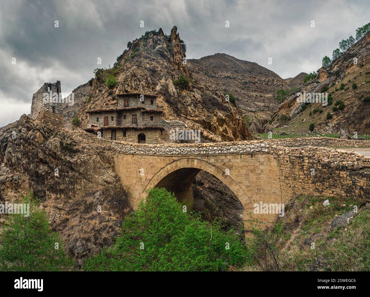 Dramatic mountain scenery with old stone bridge in dark rainy day Stock ...