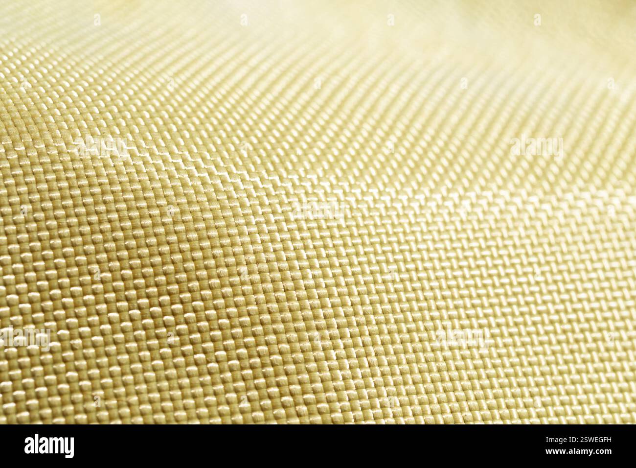 Bulletproof material aramid. Shining aramid kevlar background. Yellow kevlar texture and pattern ...