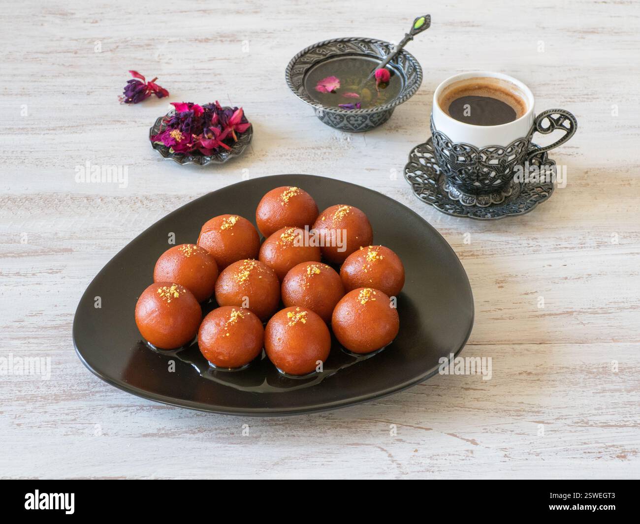 Indian sweets. Traditional sweet Gulab Jamun on a white wooden table ...