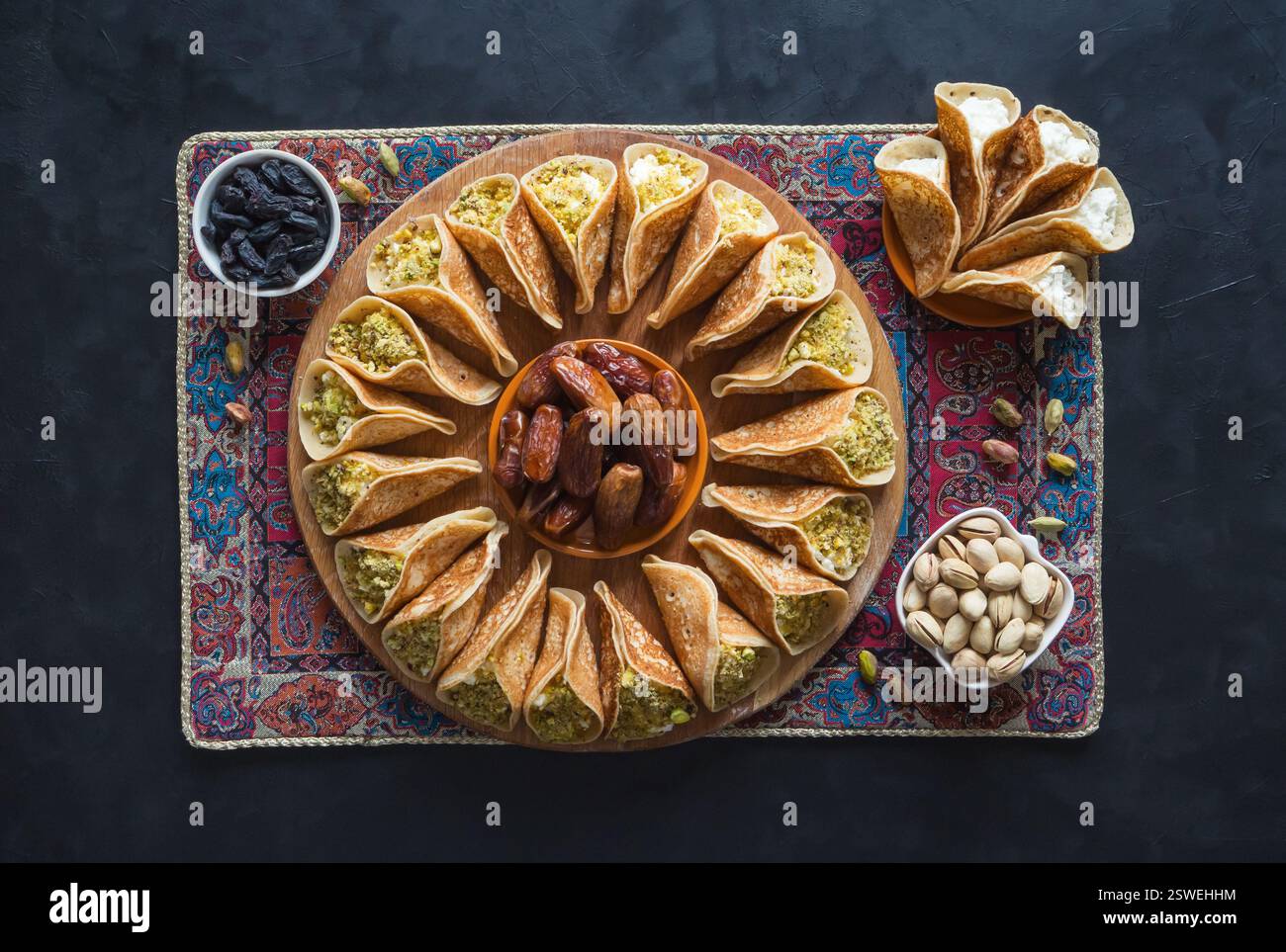 Arab sweets. Arabian pancake stuffed with sweet cheese and pistachios ...