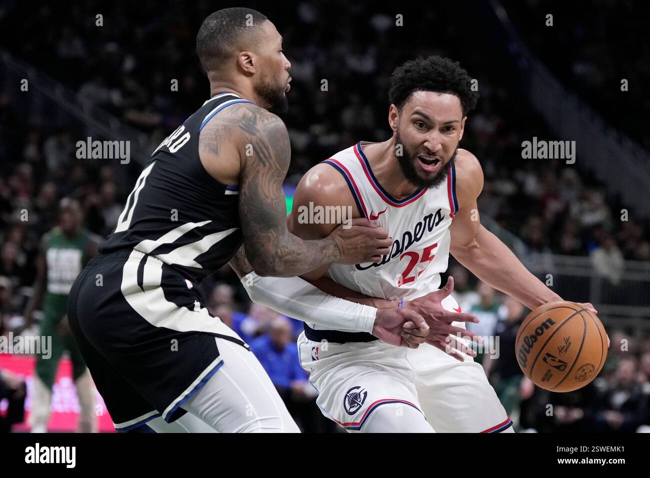 LA Clippers' Ben Simmons tries to get past Milwaukee Bucks' Damian ...